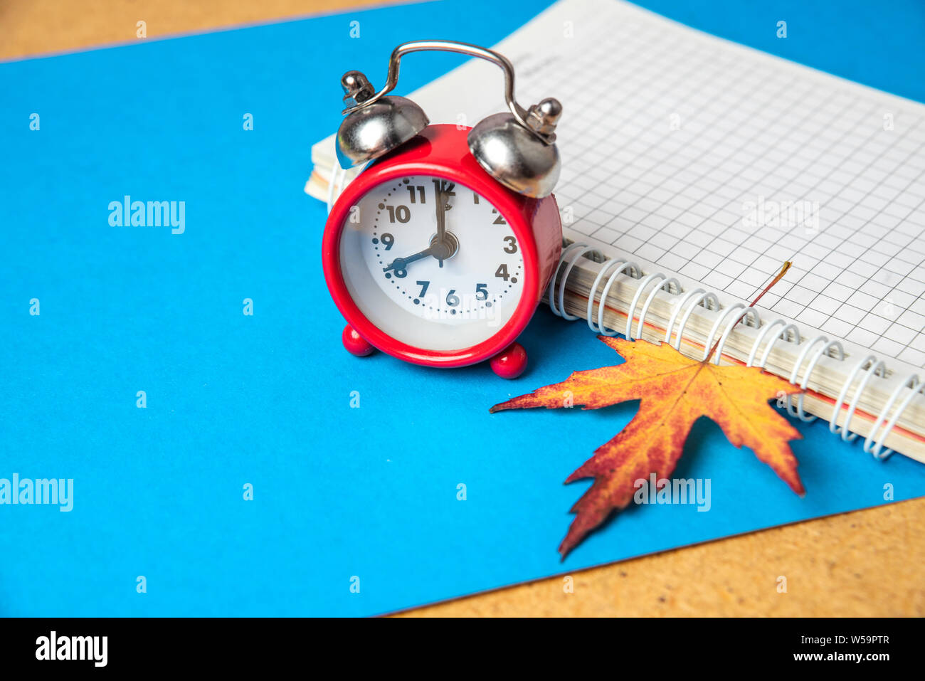 Back to school concept. Alarm clock and school supplies. Copy space ...