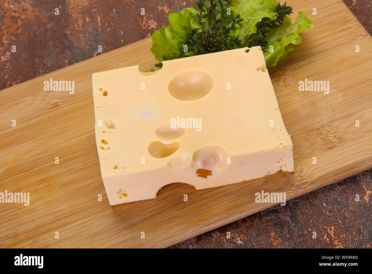Maasdam cheese brick with thyme branch Stock Photo - Alamy