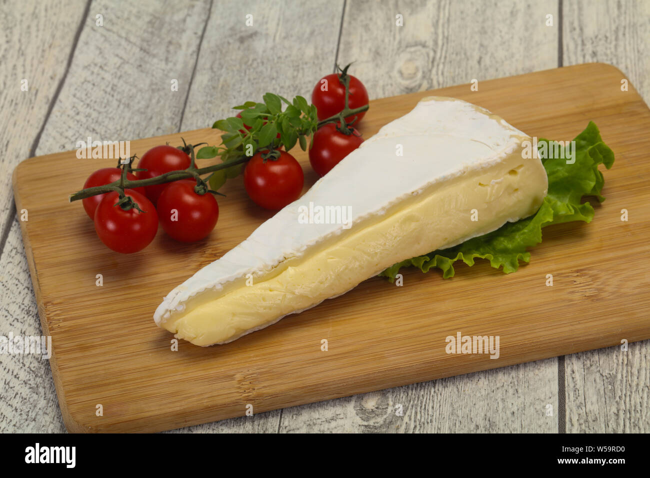 Brie cheese triangle served salad leaves Stock Photo - Alamy