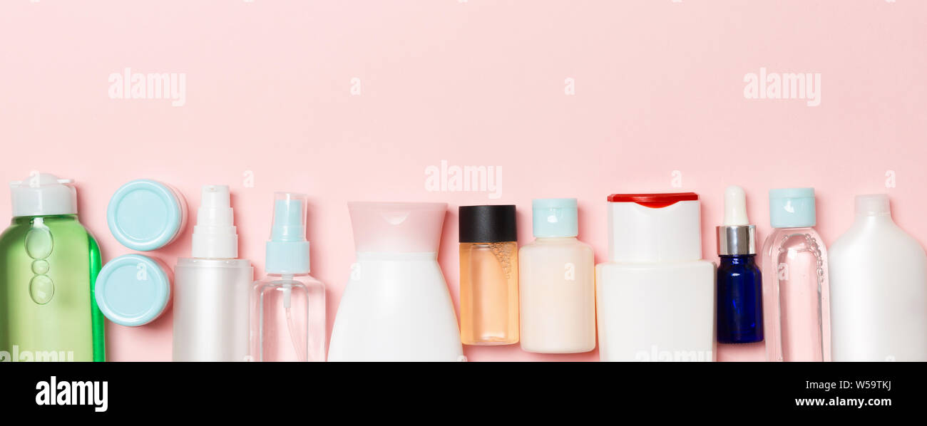 Top view of cosmetics bottles on pink background. Skin care concept ...