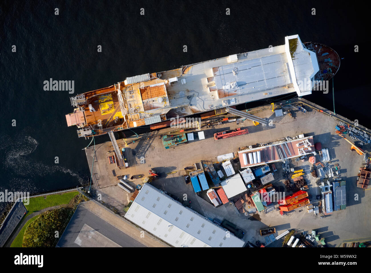 Shipbuilding aerial view at shipyard harbour with ship in construction ...