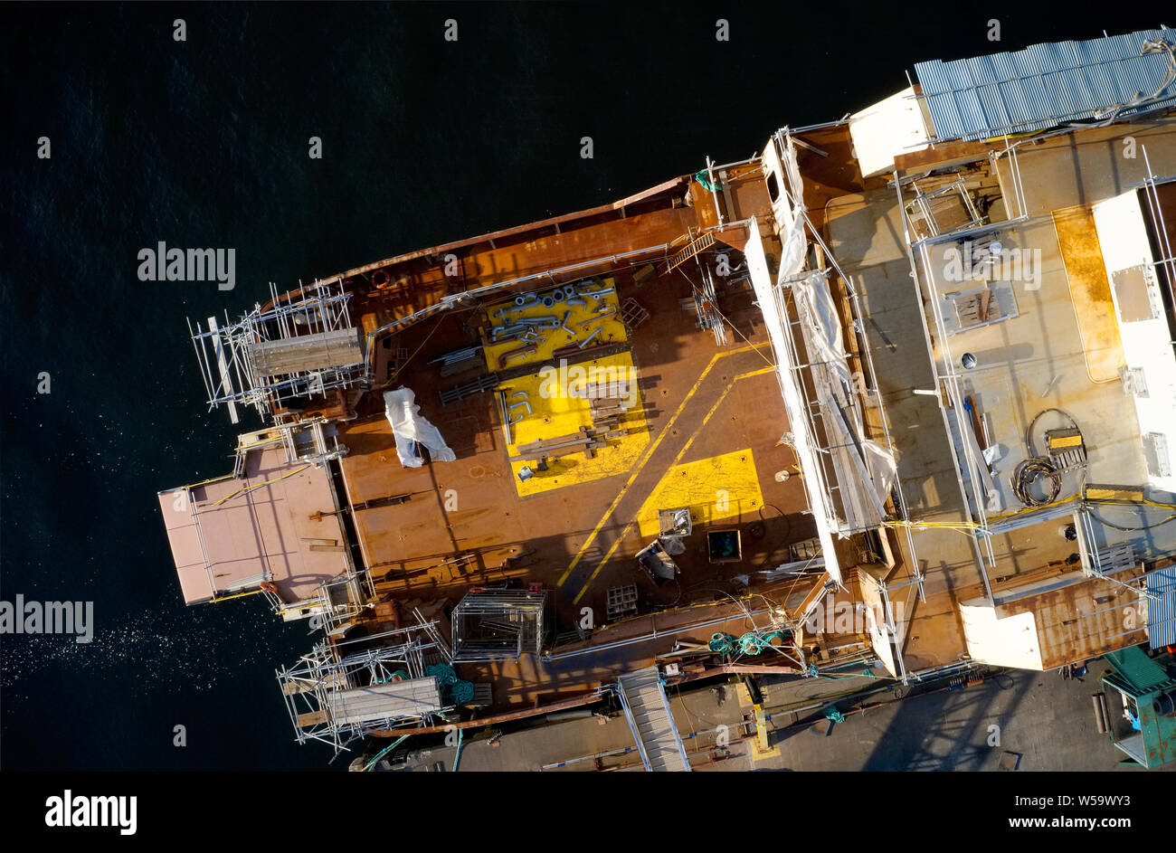 Shipbuilding aerial view at shipyard harbour with ship in construction ...