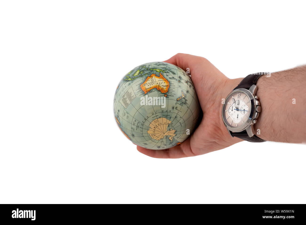 Earth globe in a human hand and the watch shows high time with white ...