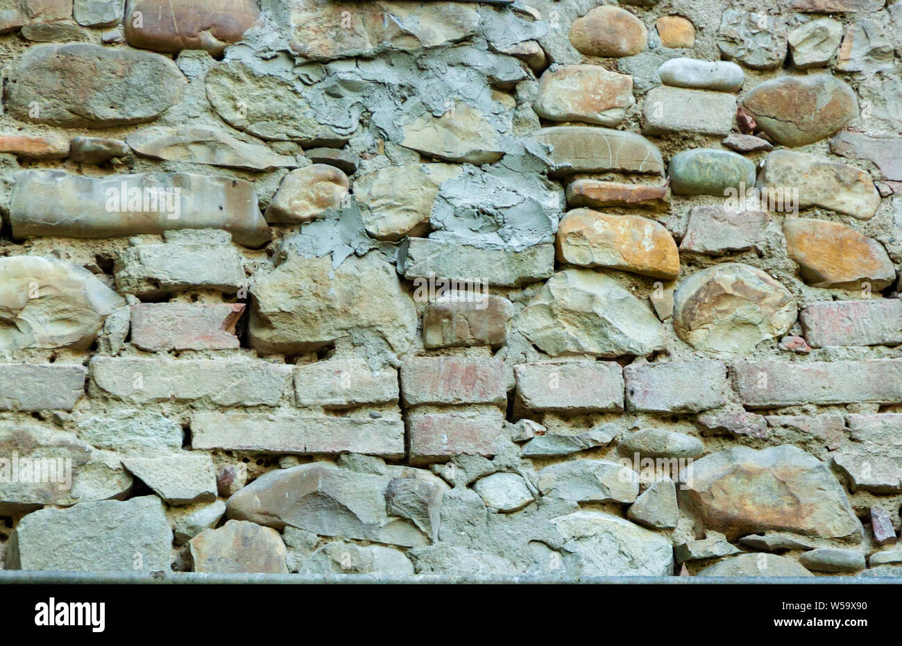 Typical wall of ancient Italian house made of hand-carved stones and ...