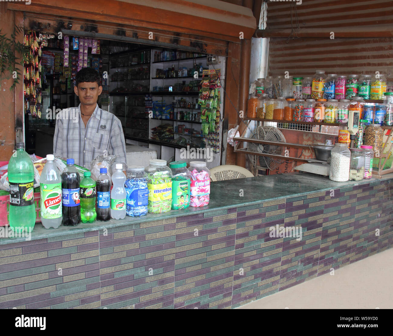 Shopkeeper in grocery shop Stock Photo - Alamy