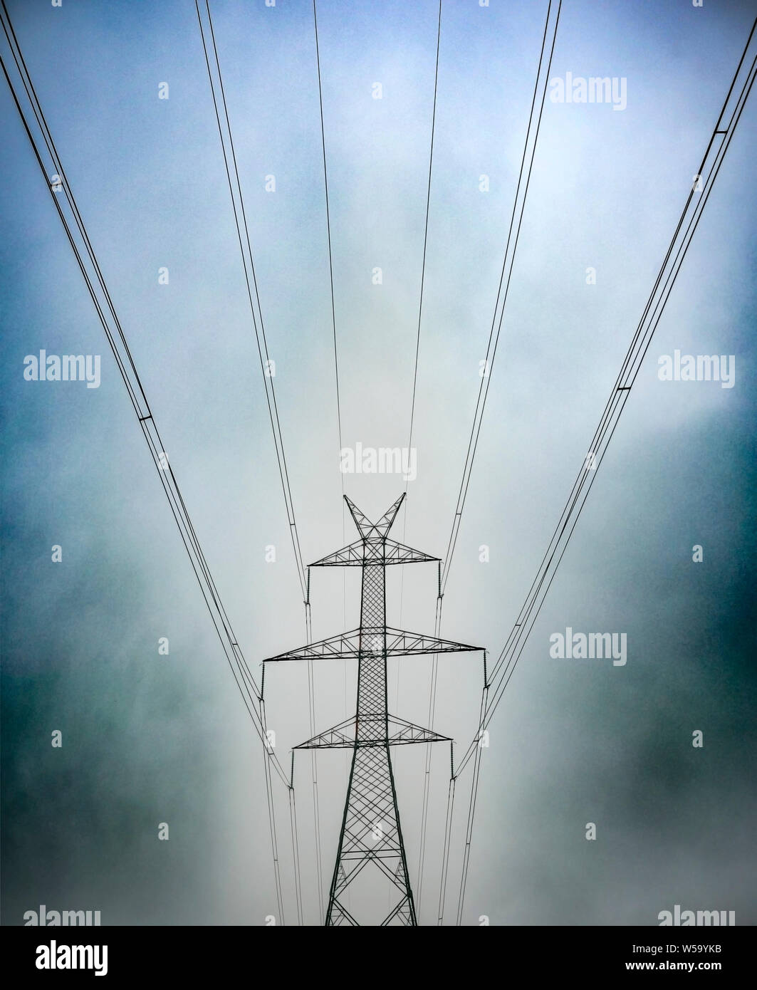 Electric pylon with cables under a dramatic sky Stock Photo - Alamy
