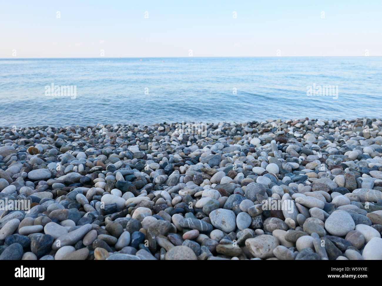 Pebble beach and blue sea Stock Photo - Alamy
