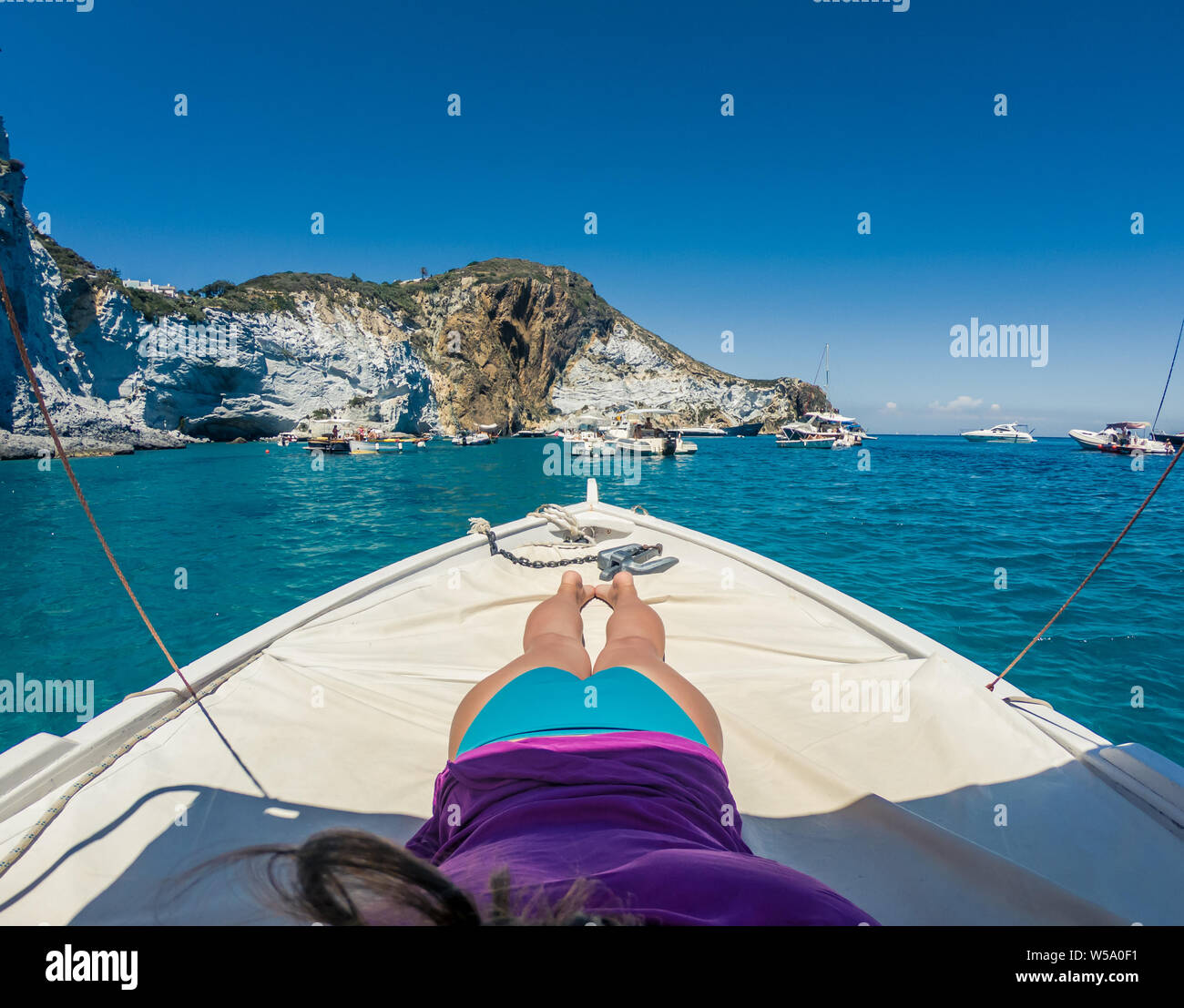 Woman legs and feet relaxing on a Boat Tanning while Sailing around ...