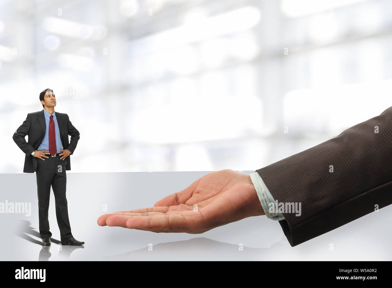 Giant man looking at small man hi-res stock photography and images - Alamy