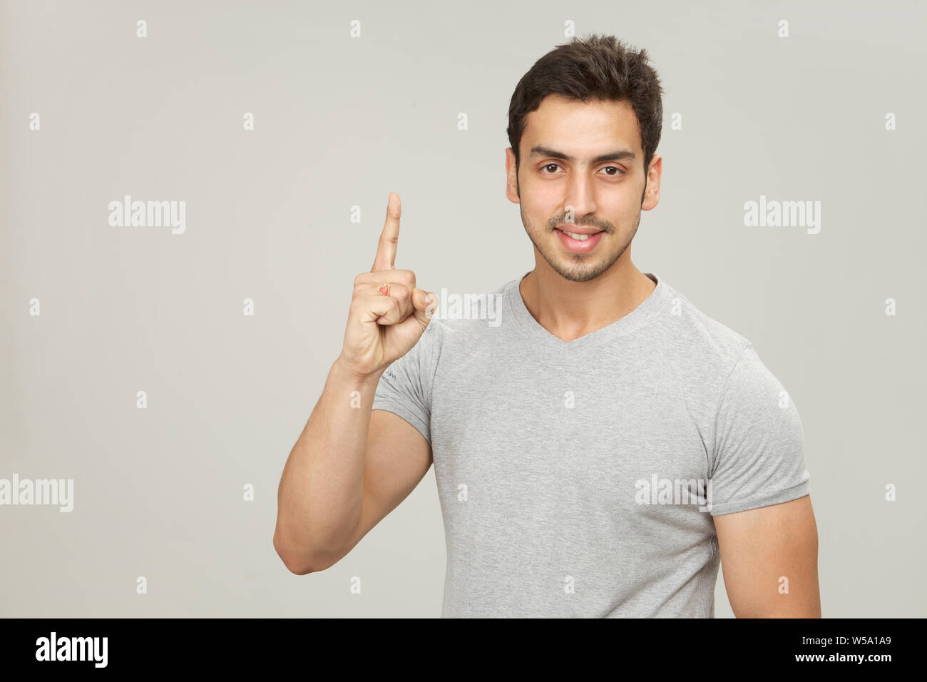 Portrait of a man pointing upward Stock Photo - Alamy