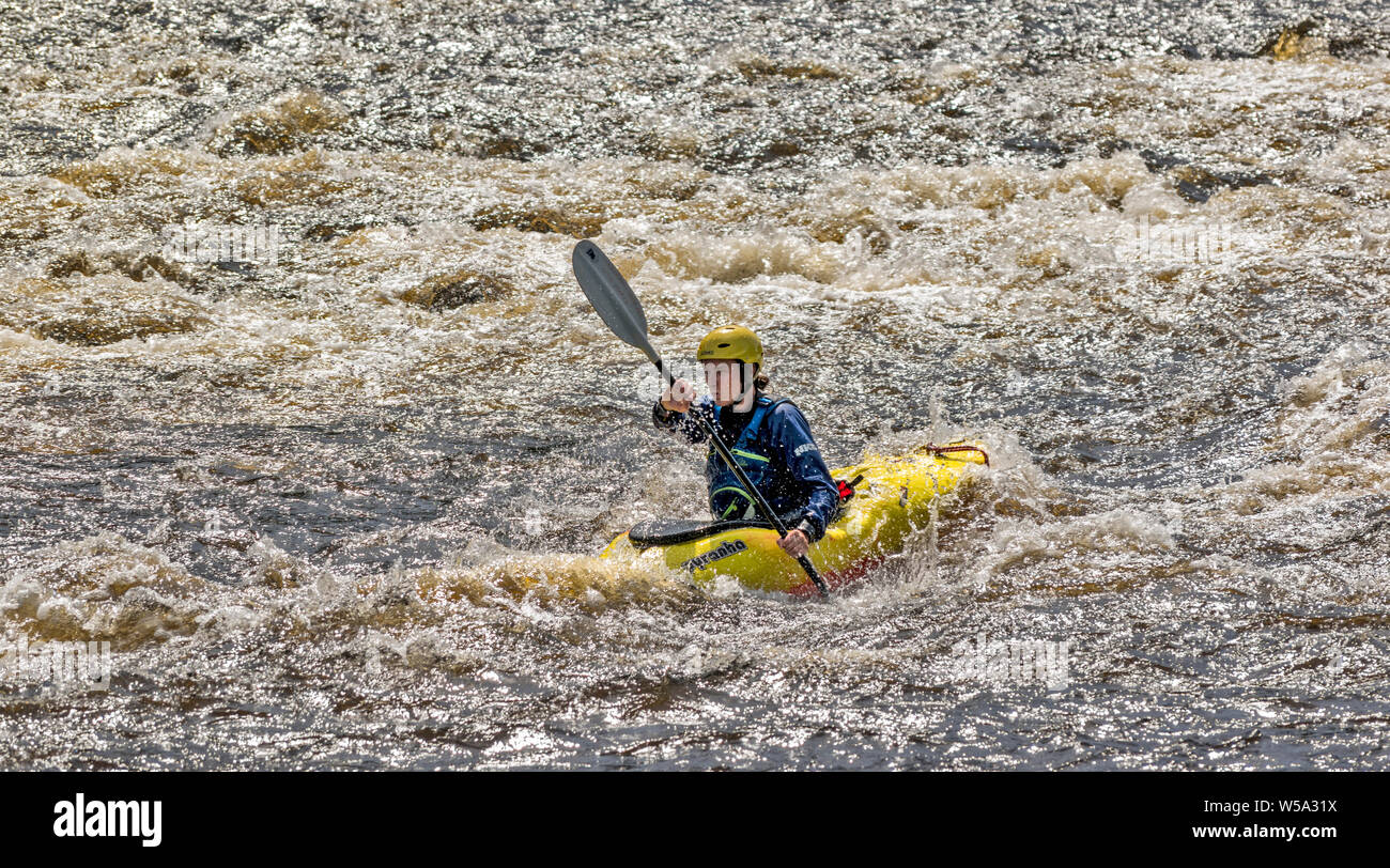 RIVER SPEY SCOTLAND YELLOW KAYAK AND PADDLER RIDING THE WHITE WATER ...