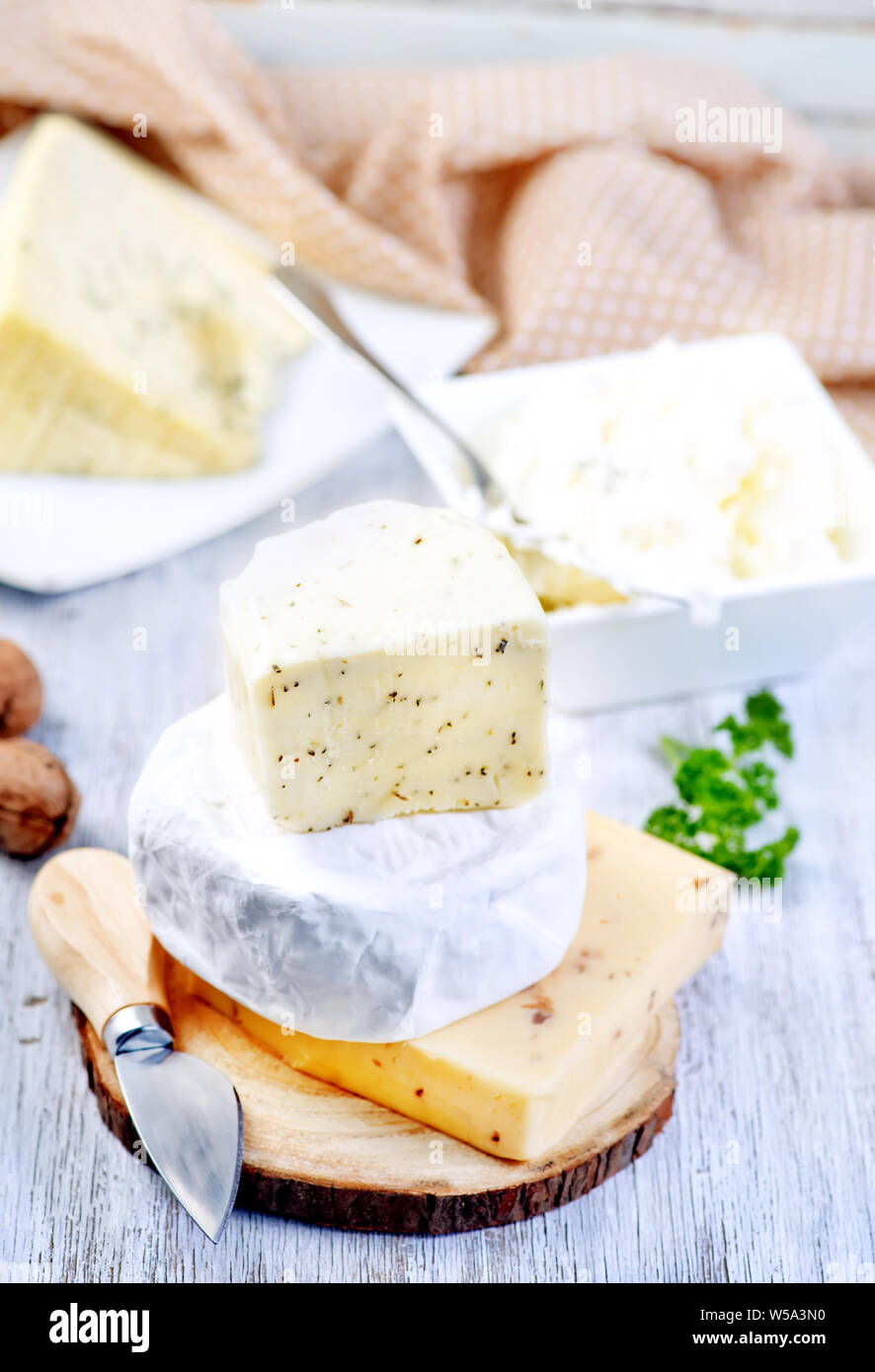 cheese on board and on a table Stock Photo - Alamy