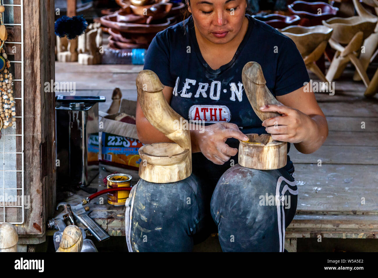 A Young Woman Working On A Wooden Penis Shaped Ashtray In A Souvenir ...