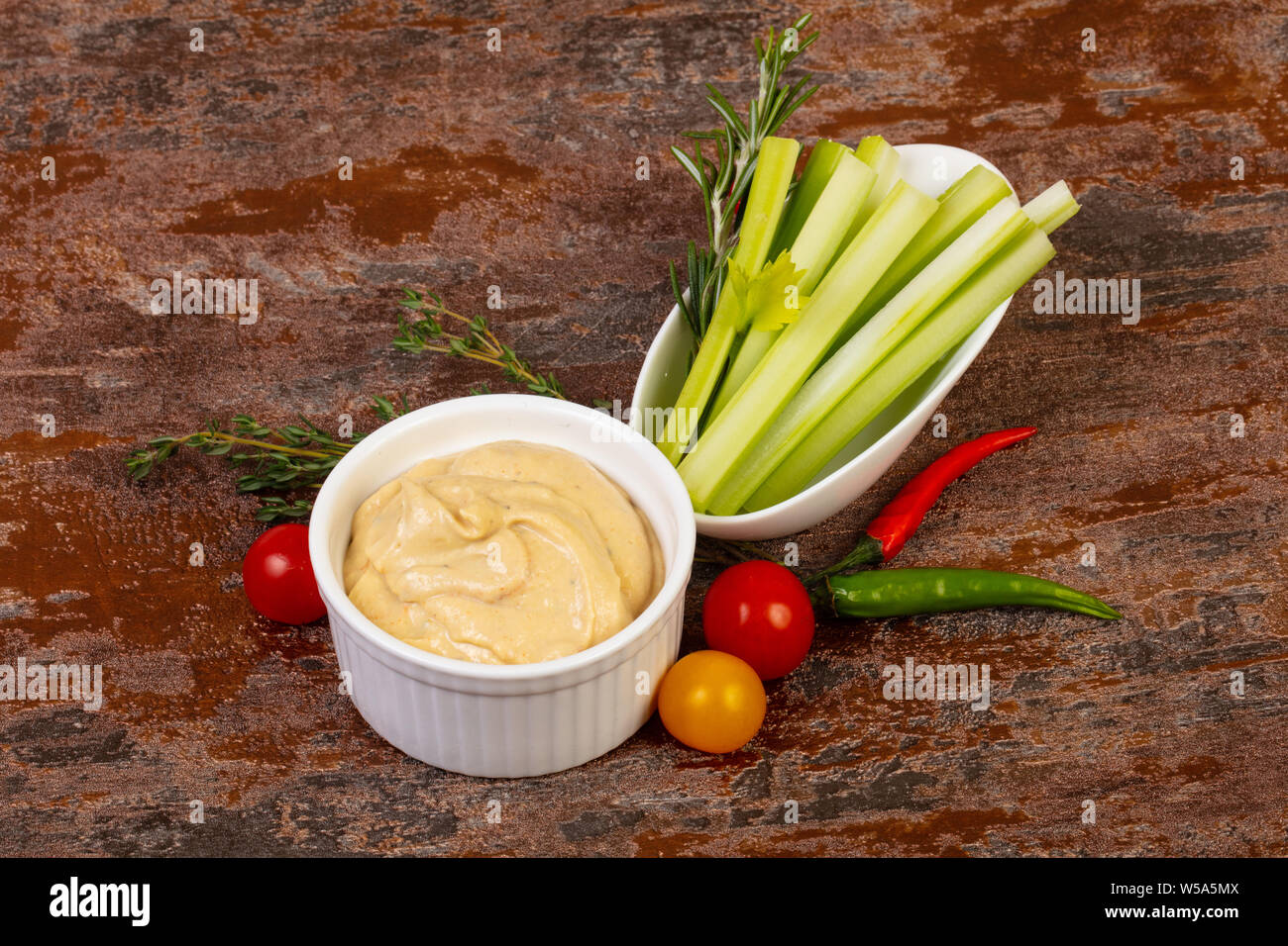 Vegan cuisine - Humus with celery sticks Stock Photo - Alamy