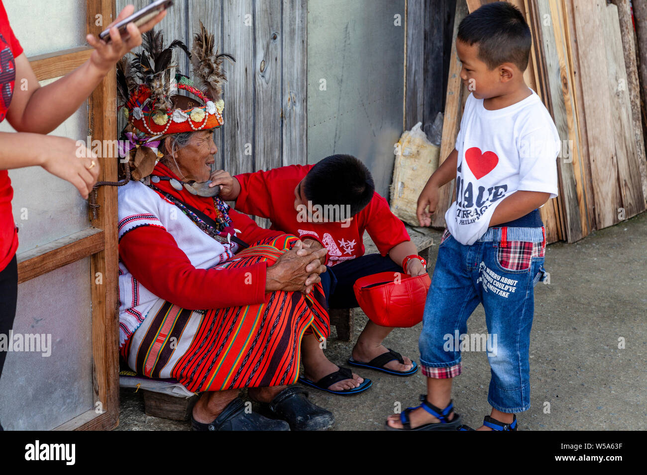 A Young Boy Is Fascinated By The Costume Worn By An Ifugao Tribal ...