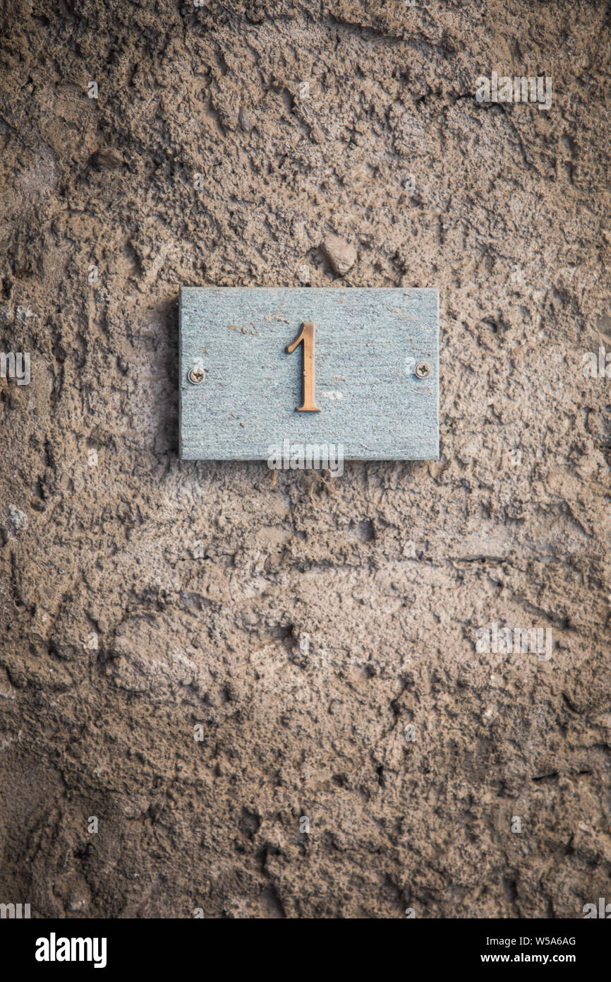 House number with number one, on a wall Stock Photo - Alamy