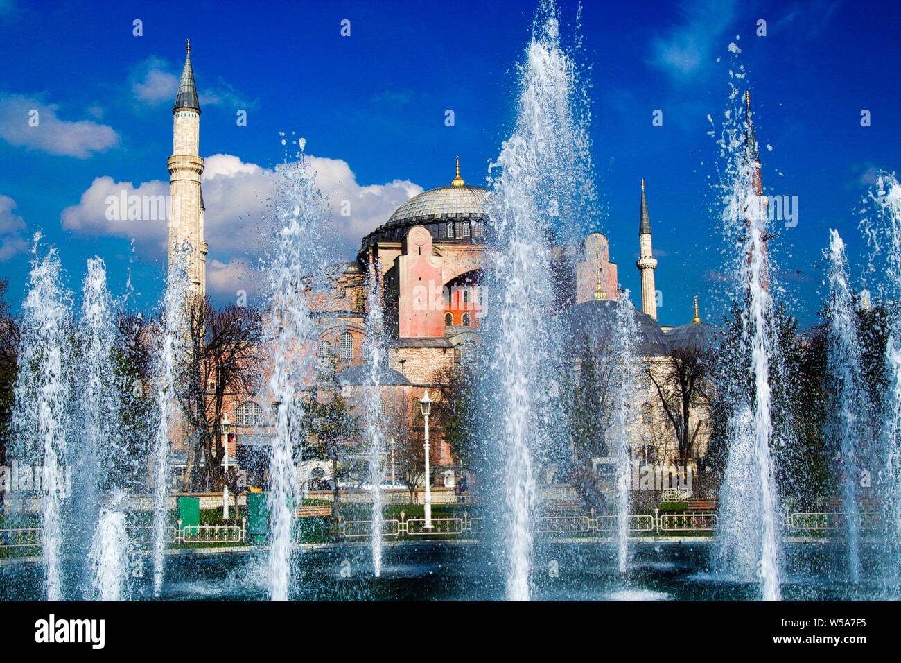 Hagia Sophia church against blue sky behind water fountains, Istanbul ...