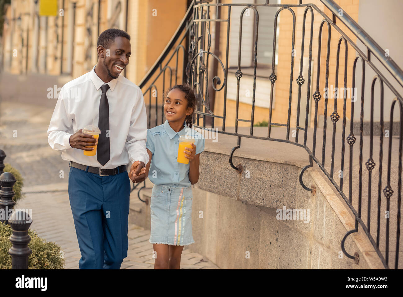 Positive delighted young daddy laughing at funny joke Stock Photo - Alamy