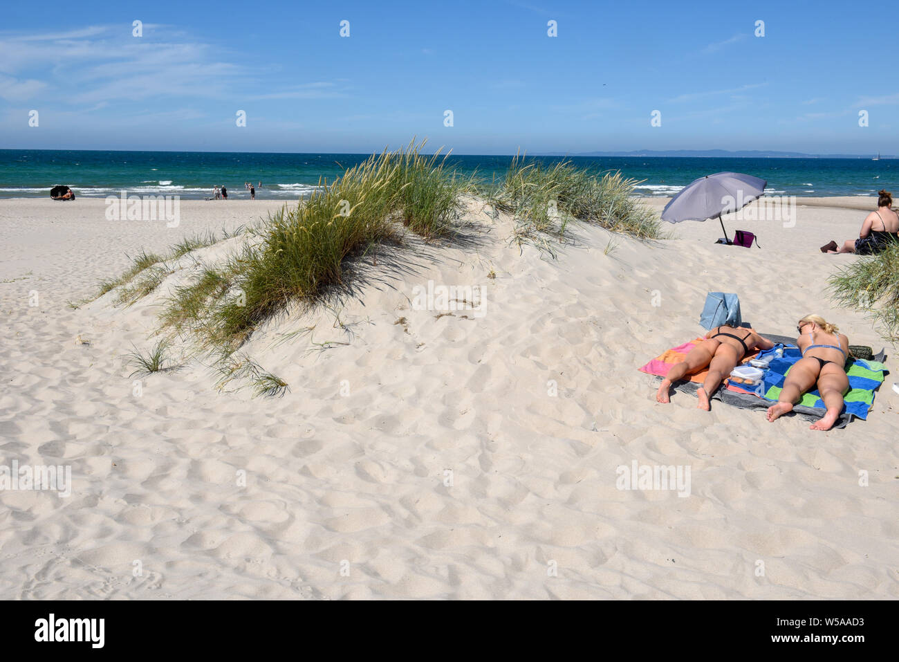 Hornbaek, Denmark - 28 June 2019: people sunbathing on the beach of ...