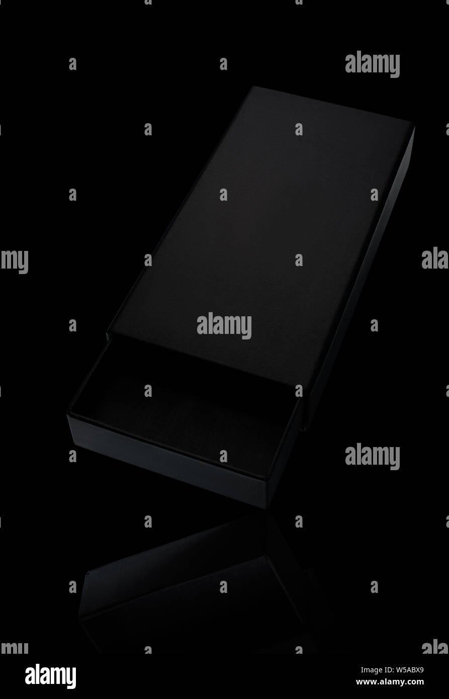 Open empty slick black gift box with reflection on black background ...