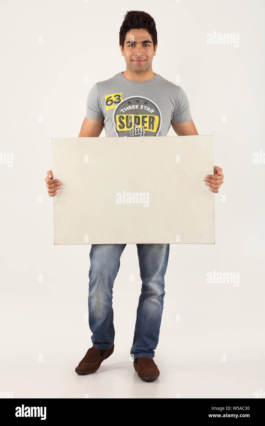 Man standing and showing a placard Stock Photo - Alamy
