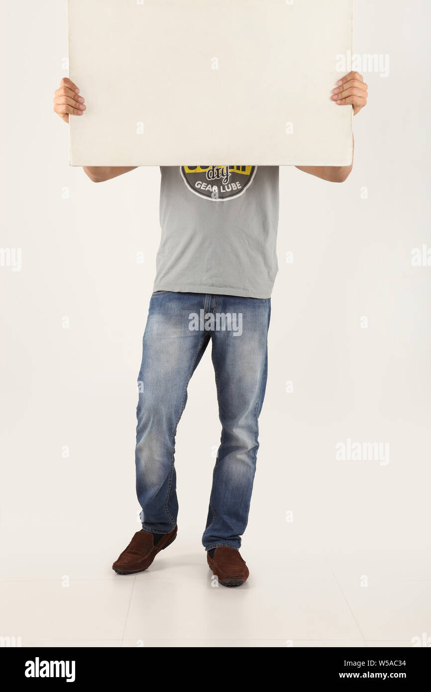Indian man showing a placard in front of his face Stock Photo - Alamy