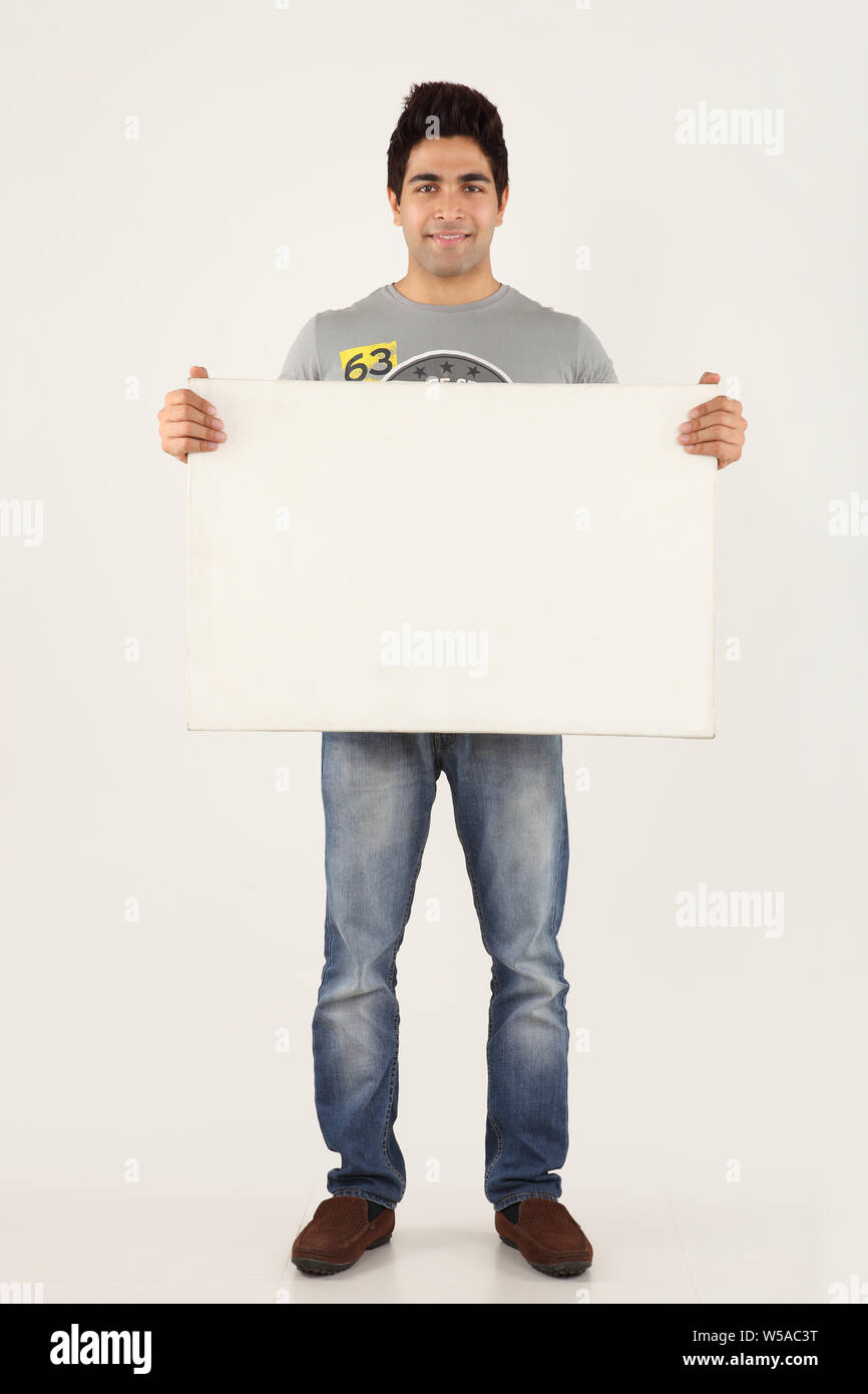Man standing and showing a placard Stock Photo - Alamy