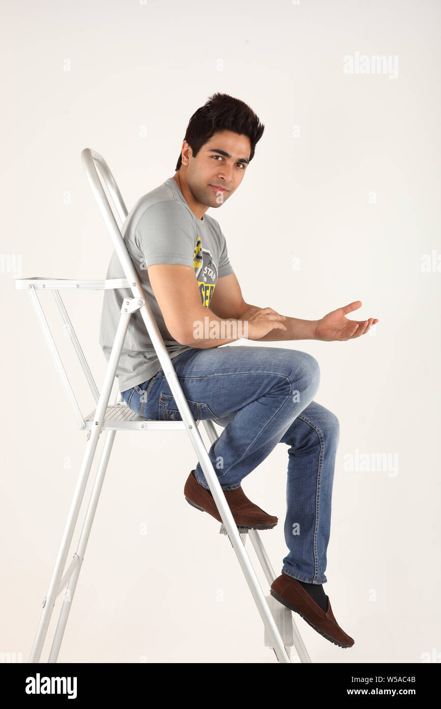 Man sitting on a step ladder Stock Photo - Alamy