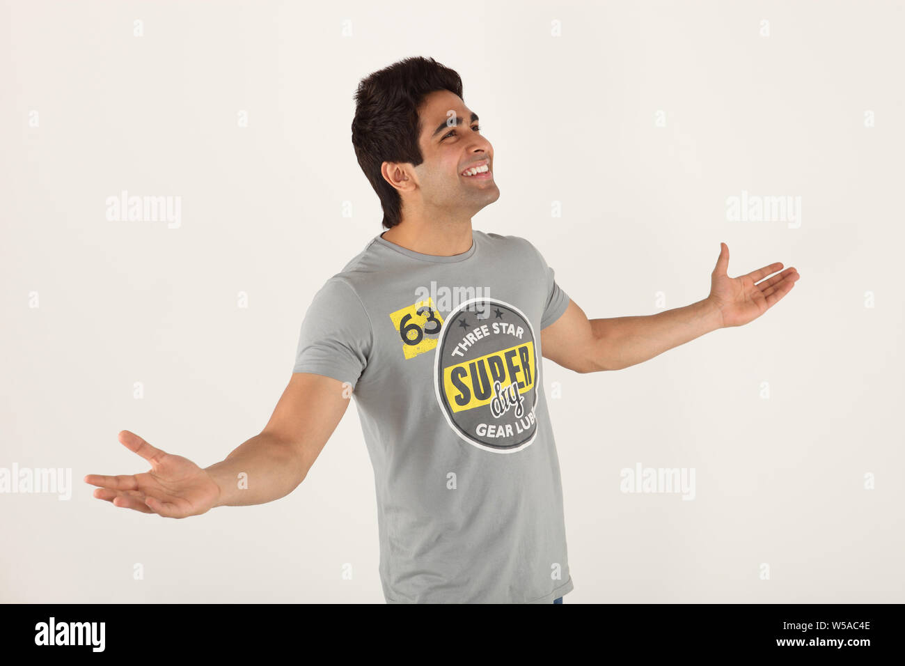 Man smiling with his arm outstretched Stock Photo - Alamy