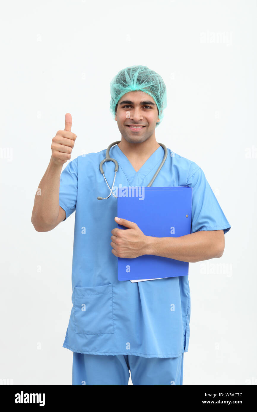 Male surgeon holding medical report and showing thumbs up sign Stock ...