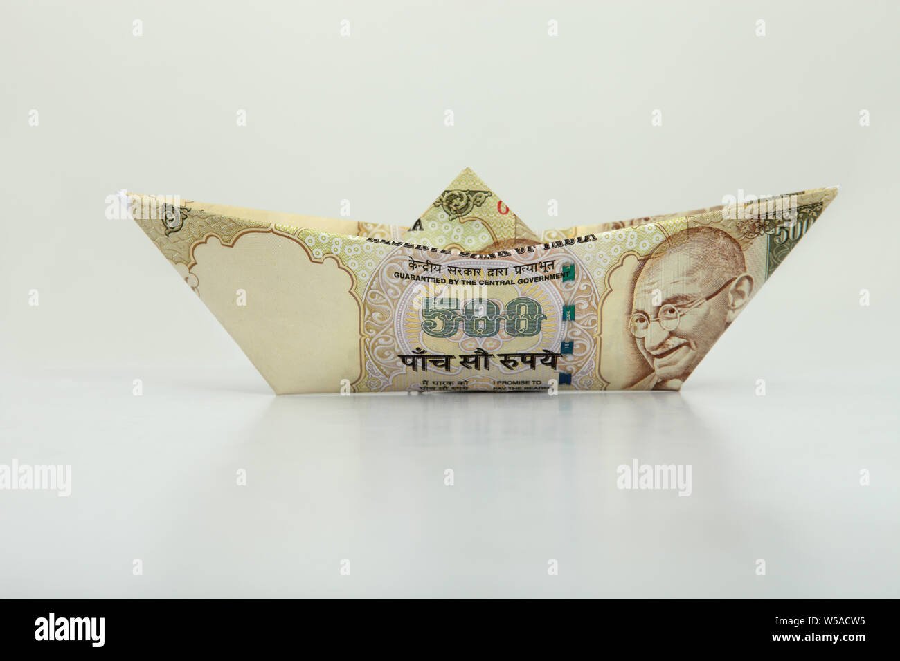 Paper boat of five hundred rupee note on white background Stock Photo ...