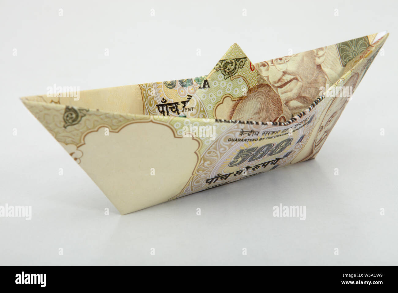 Paper boat of five hundred rupee note on white background Stock Photo ...