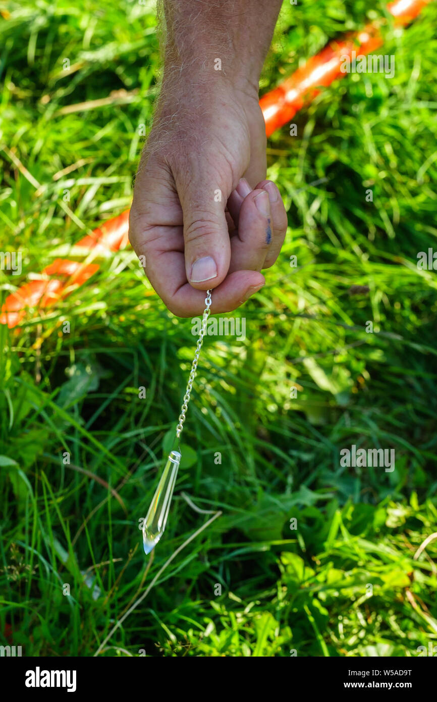 Hand holding pendulum hi-res stock photography and images - Alamy
