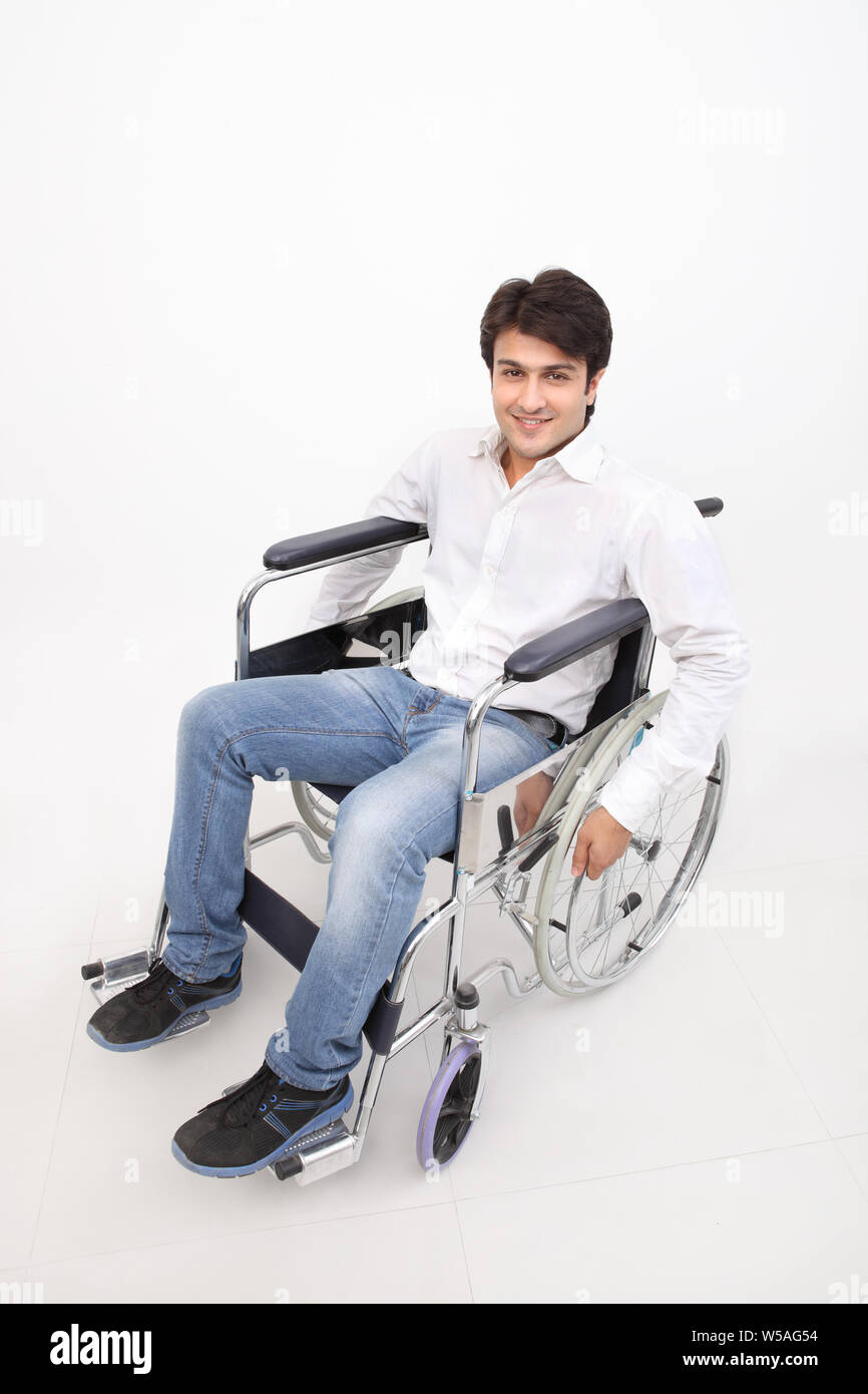 Man sitting in a wheelchair and smiling Stock Photo - Alamy