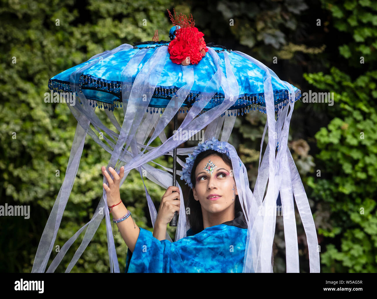 Rebecca Press in character dressed as a humanoid Pokemon during the MCM ...