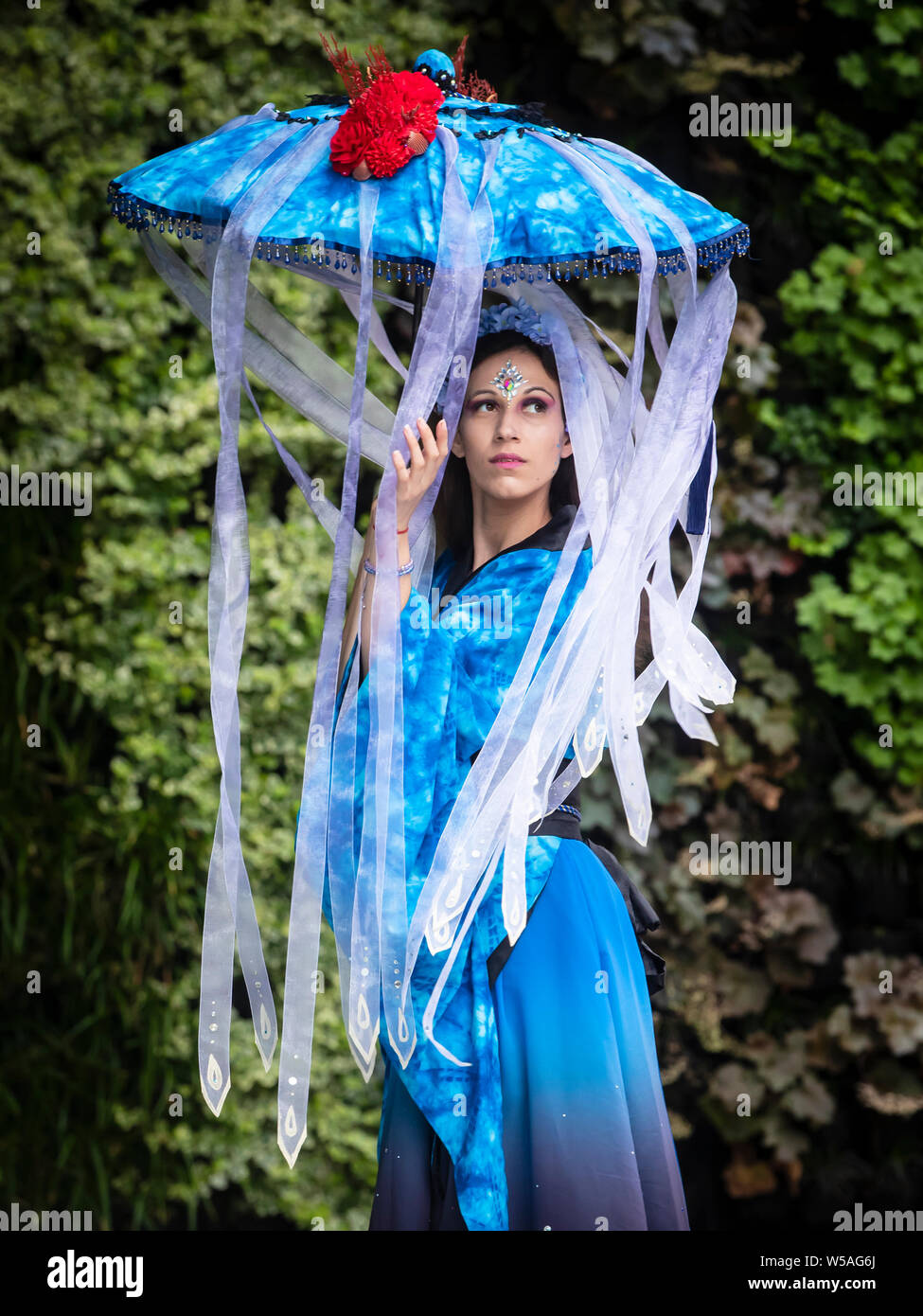Rebecca Press in character dressed as a humanoid Pokemon during the MCM ...