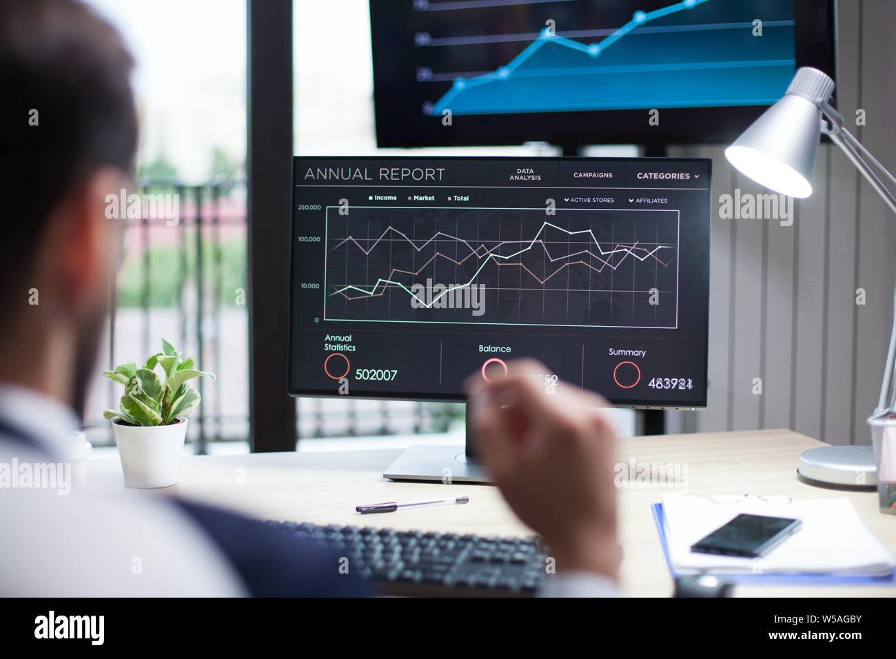 Businessman sitting desk diagrams laptop hi-res stock photography and ...