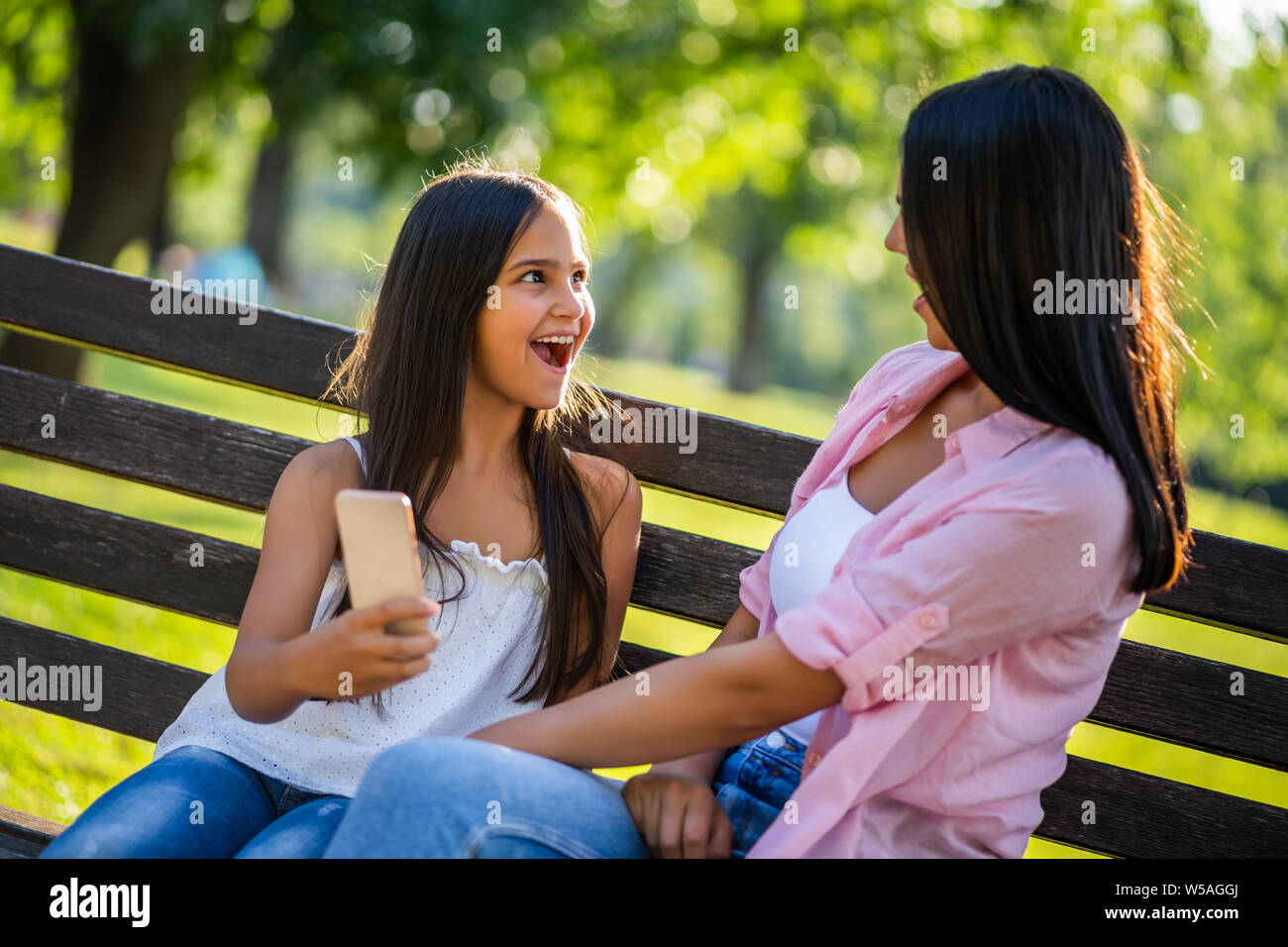 Happy family having nice time in park together. They are using ...