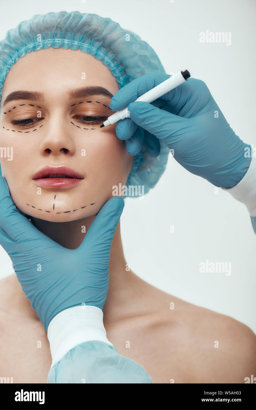 Beautiful patient. Young woman in blue medical hat waiting for facial ...