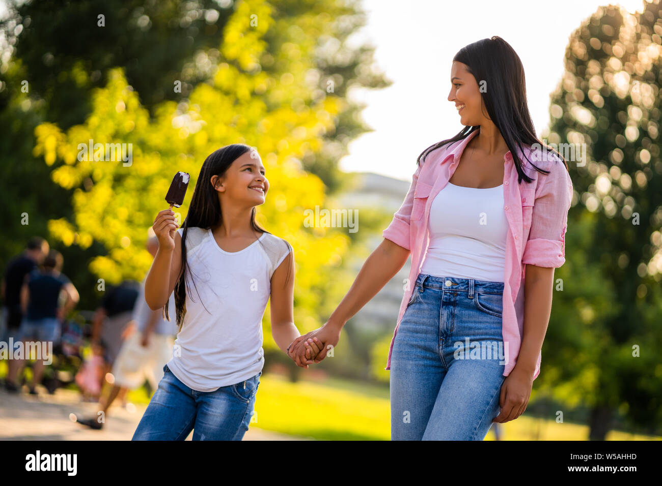 Happy family having nice time in park together Stock Photo - Alamy