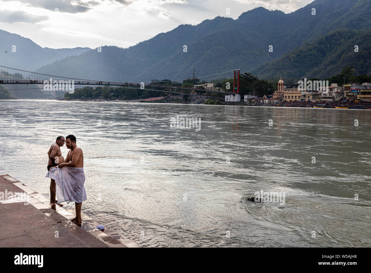 Two men bathe along the ghats of the River Ganga in the spiritual town ...