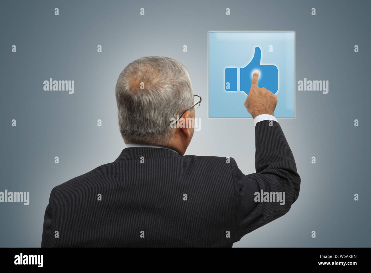 Rear view of a businessman using on touch screen Stock Photo - Alamy