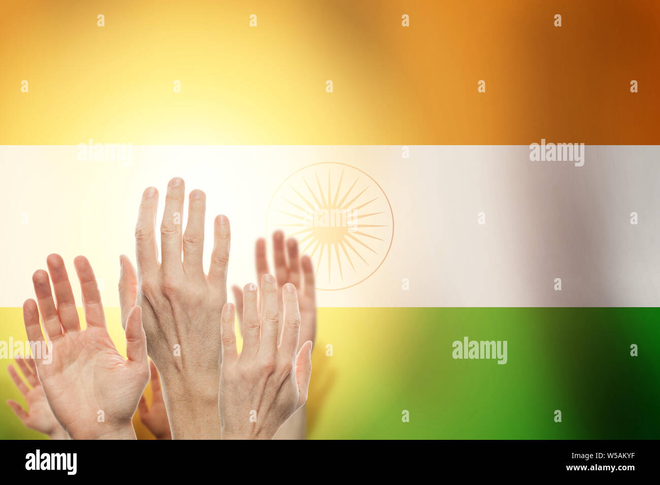 People raising hands and flag India on background. Patriotic concept ...
