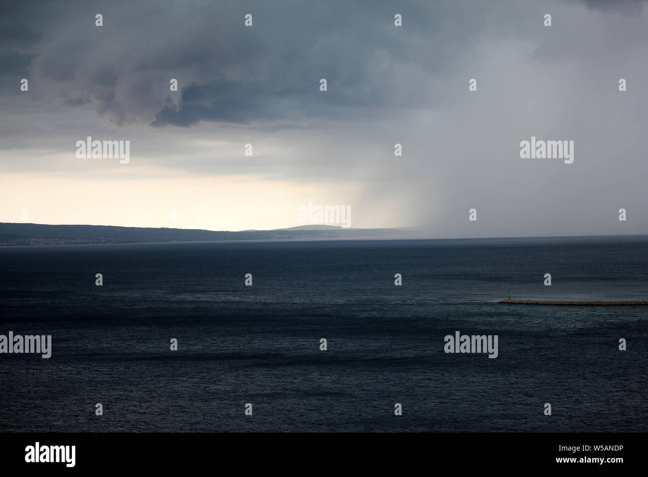Supercell storm with dramatic dark cloud and rainstorm at the sea Stock ...