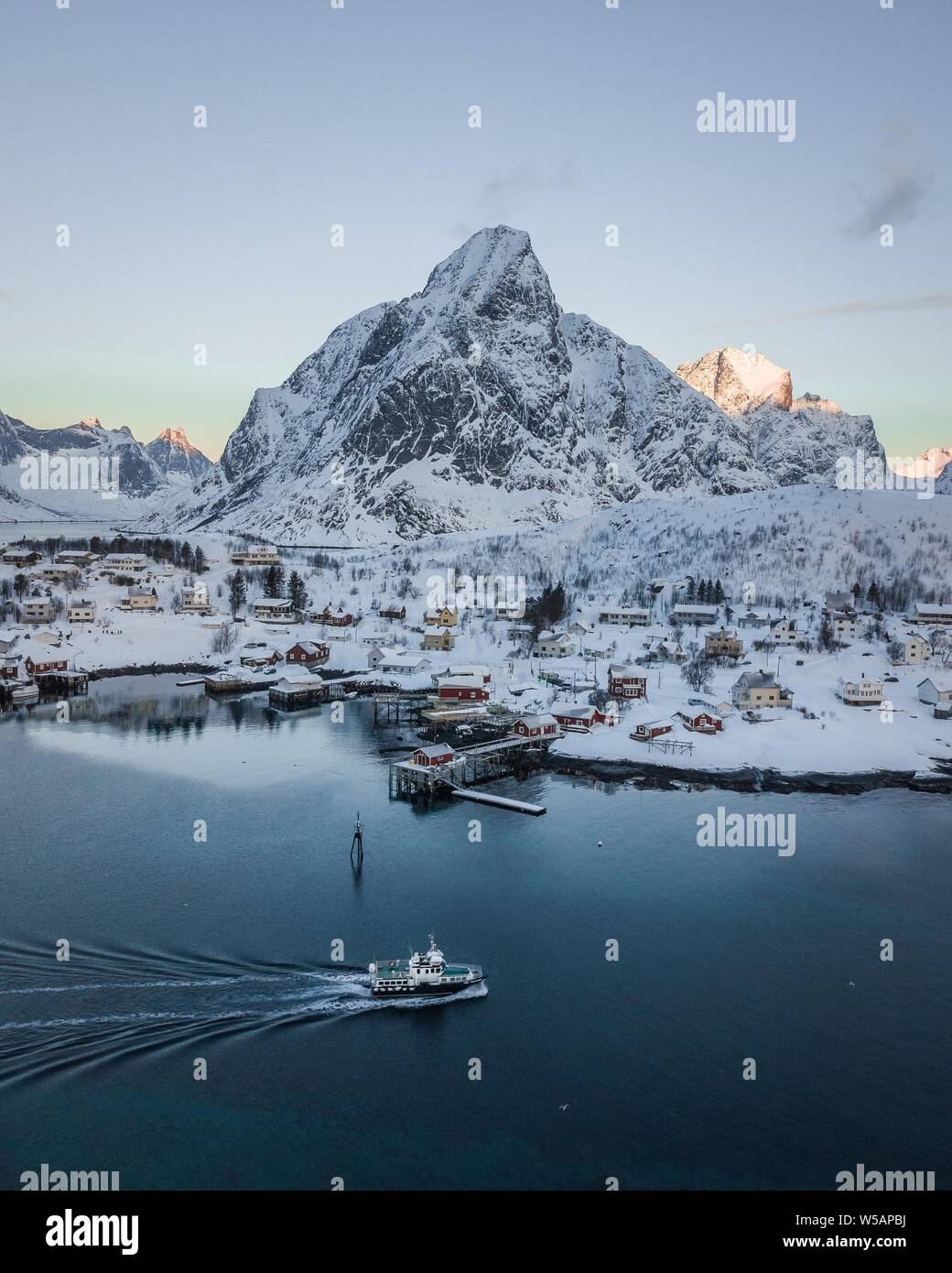 Place reine voe snowy mountains with passenger boat hi-res stock ...