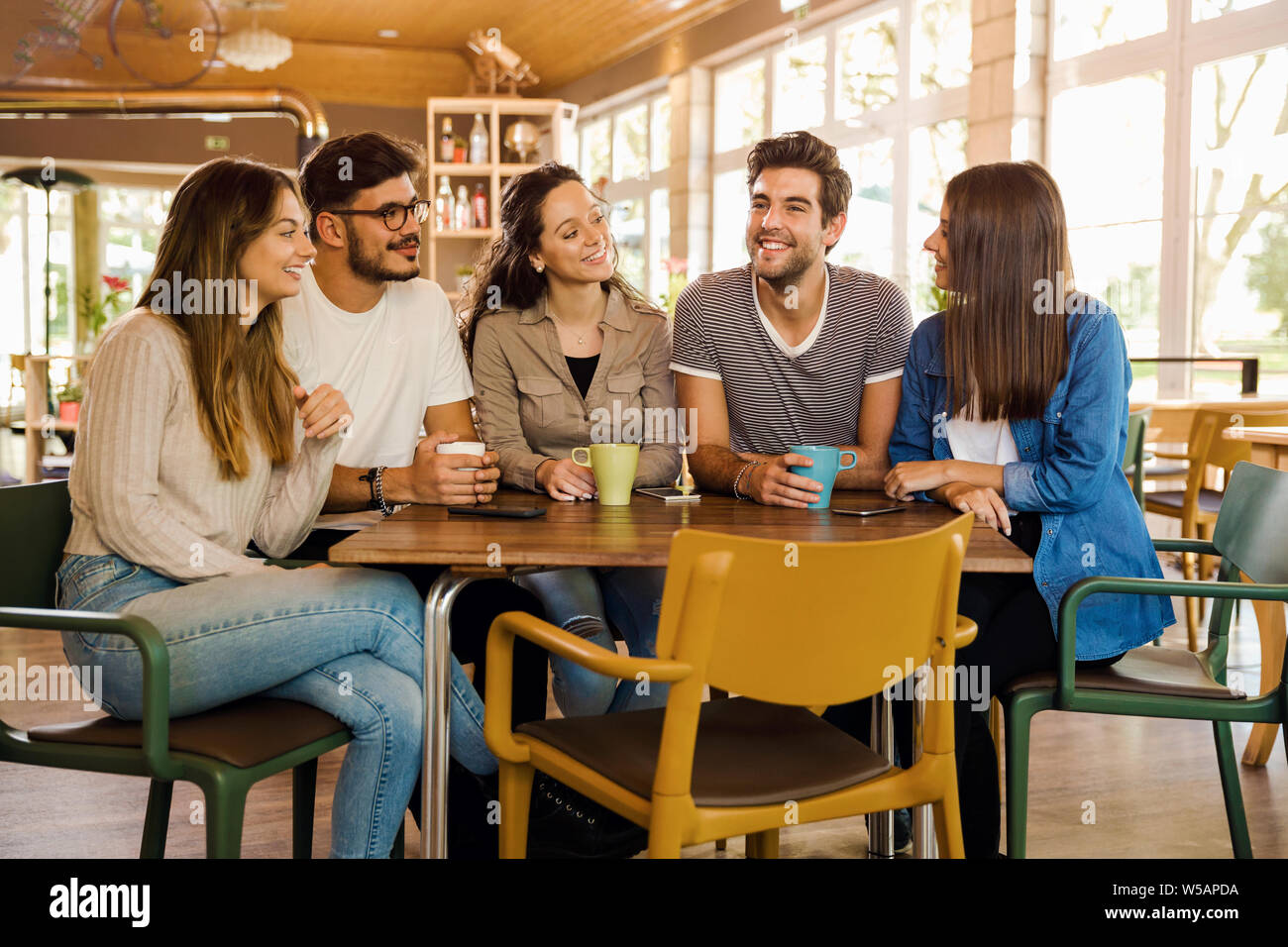 A group of friends talking and drinking coffee at the cafe Stock Photo ...