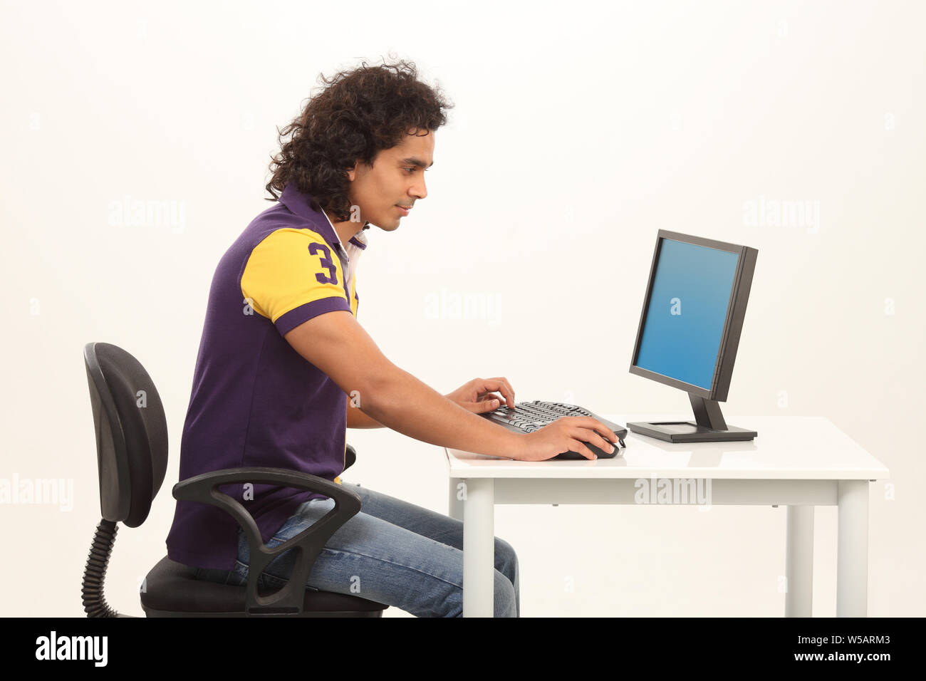 Indian young man working on a desktop pc Stock Photo - Alamy
