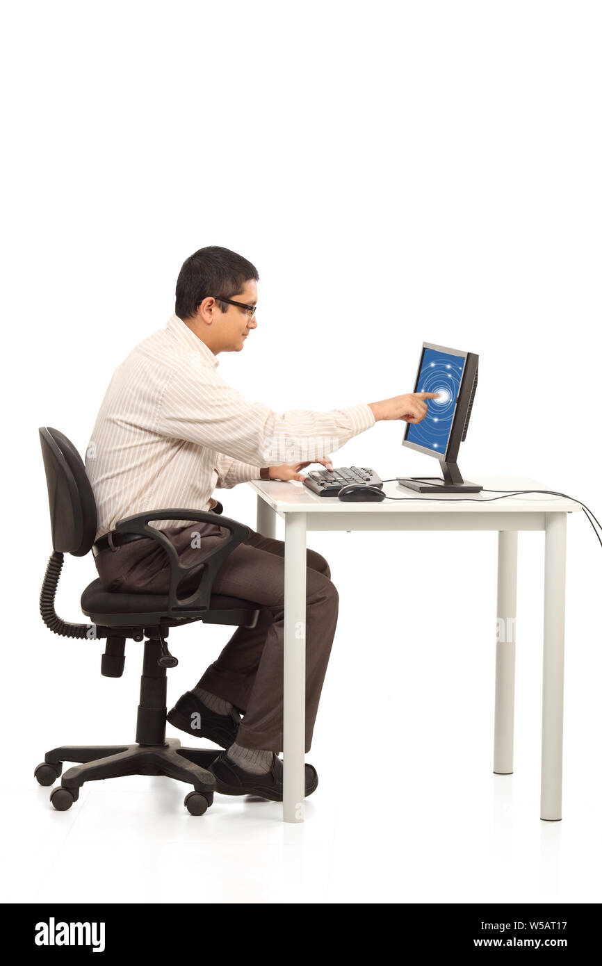 Indian man working at desktop Cut Out Stock Images & Pictures - Alamy