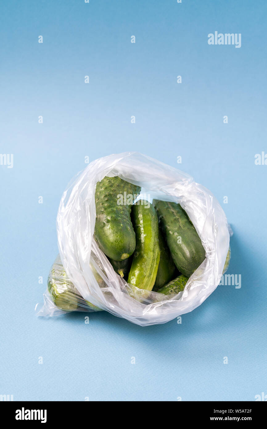 Front view Cucumbers in plastic bag on blue background. Image shows the ...