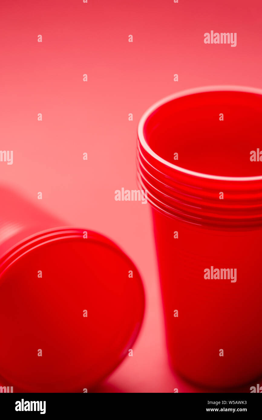 Red plastic glasses on a red background Stock Photo - Alamy